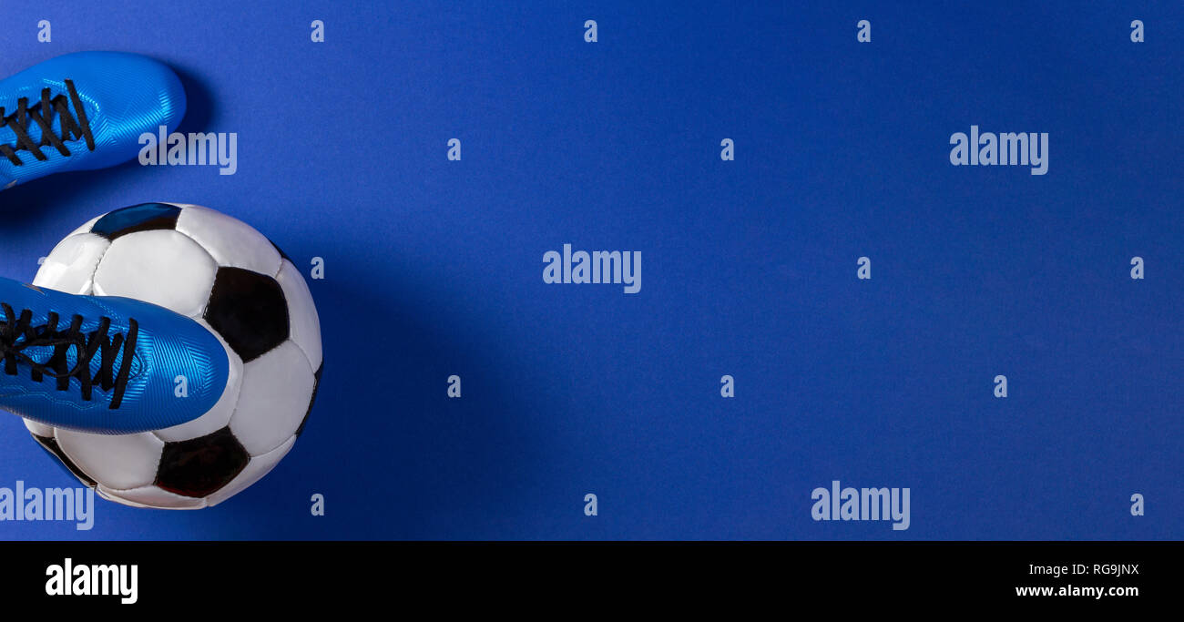 Soccer ball under soccer players feet on blue background Stock Photo ...