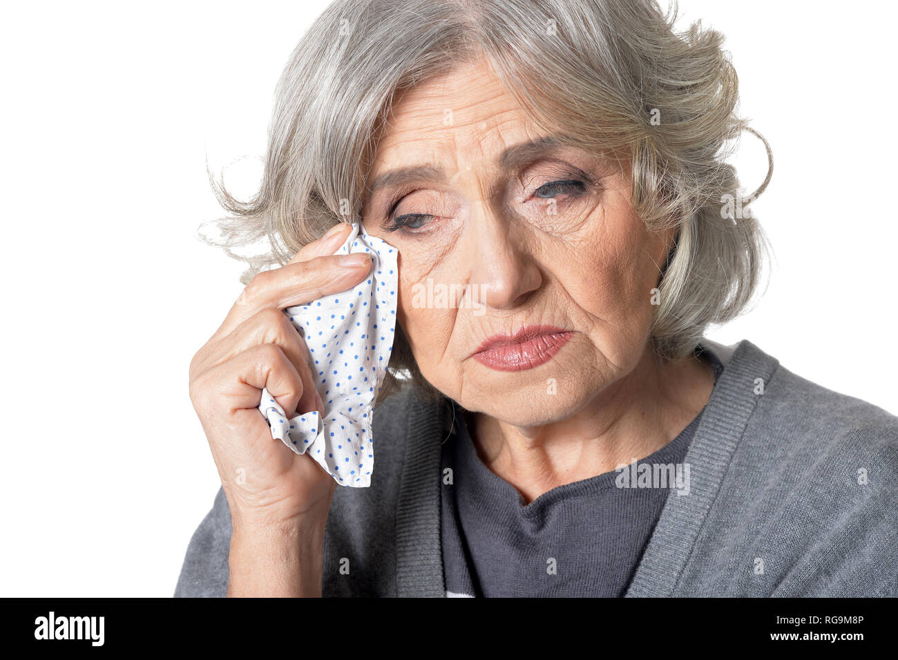sad senior woman crying posing on white background Stock Photo - Alamy