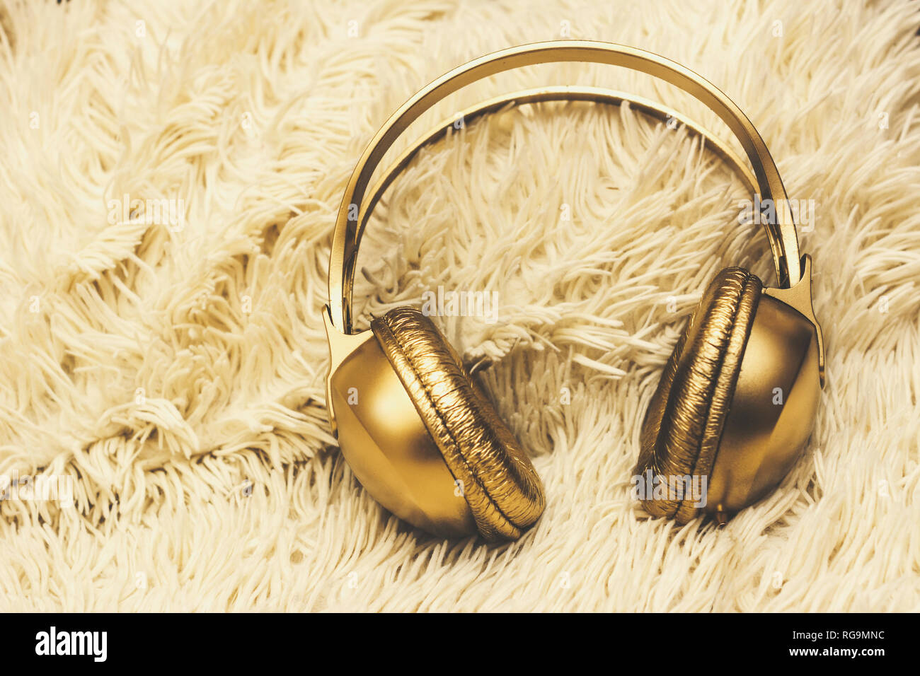 funny headphones with golden on shaggy bedspread, relaxation, hygge ...
