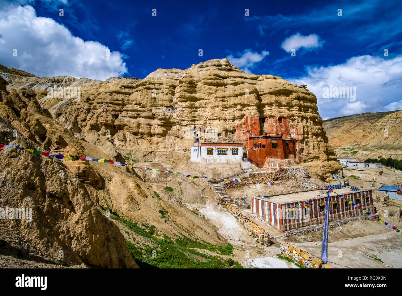 Aerial view on local monastery Nifuk Gompa, located below a rock cliff ...