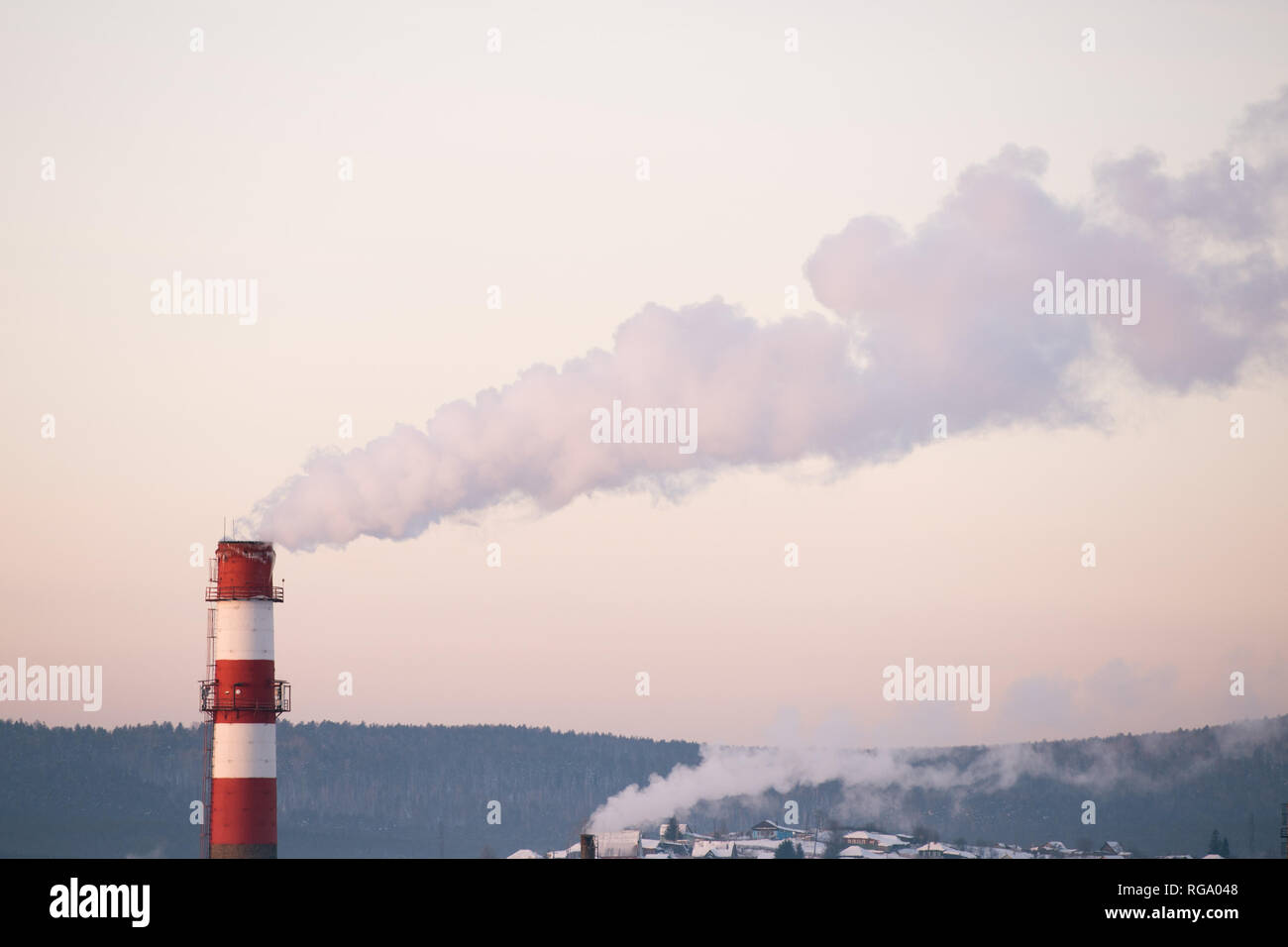 Thick smoke coming from the factory chimneys. Large pipe boiler. There ...
