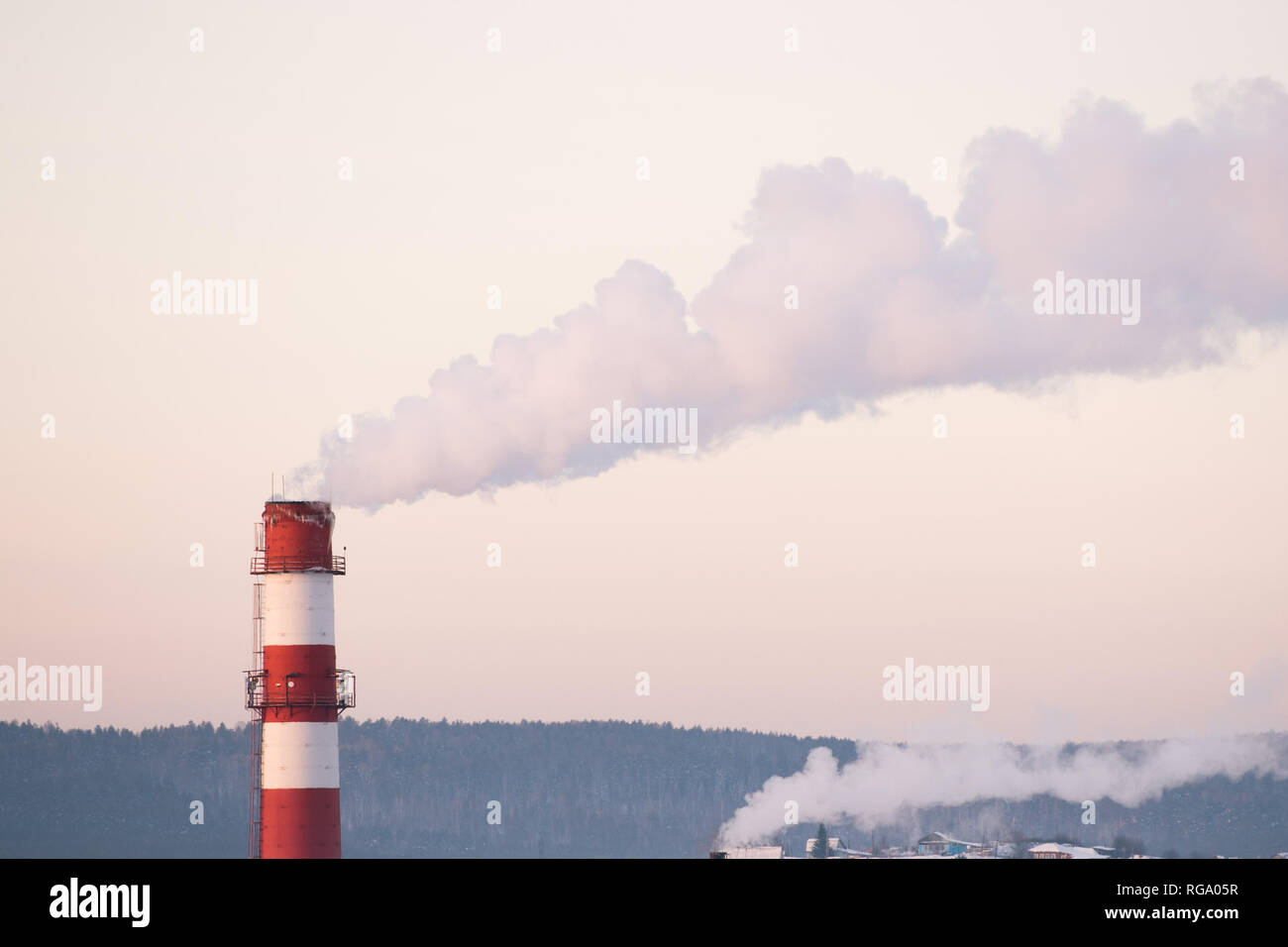 Thick smoke coming from the factory chimneys. Large pipe boiler. There ...