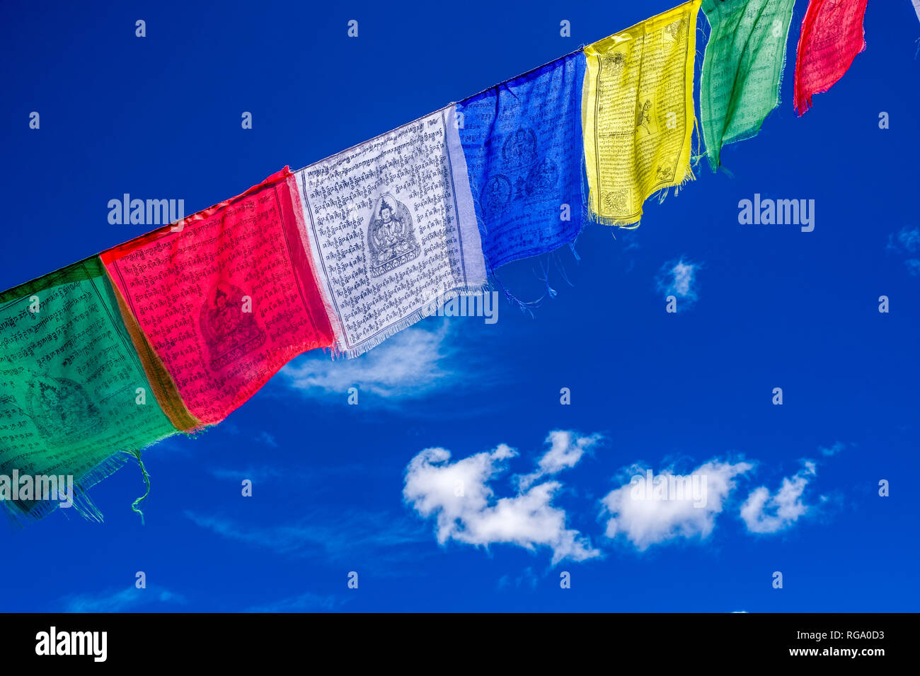 Colorful buddhist prayer flags are fluttering under blue sky Stock ...