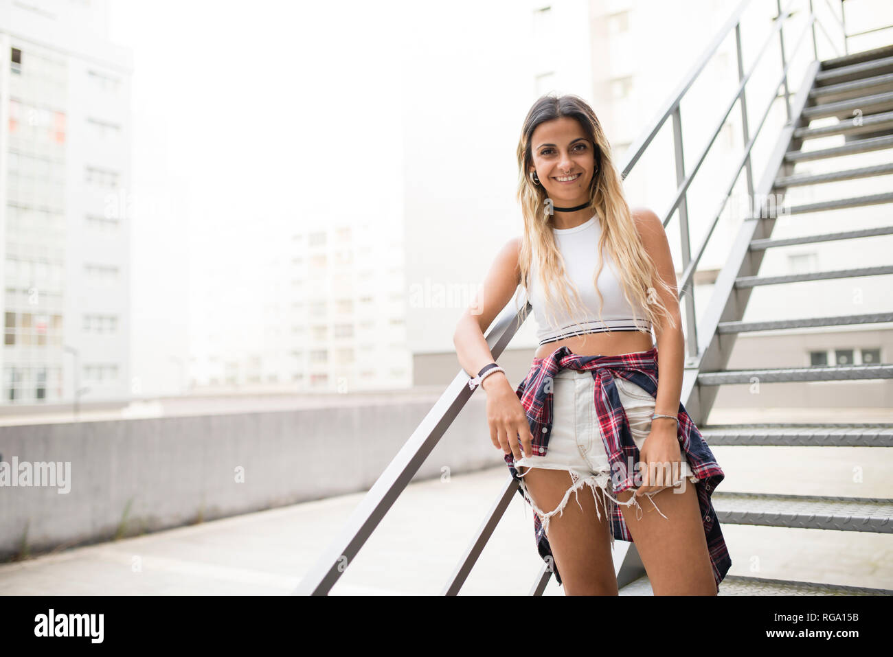 Young woman standing stairs hi-res stock photography and images - Alamy