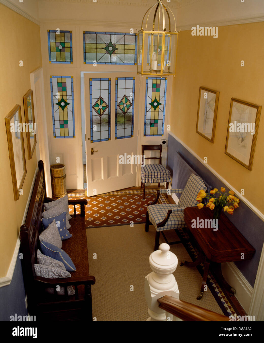 Hall with stained glass panels in front door Stock Photo - Alamy