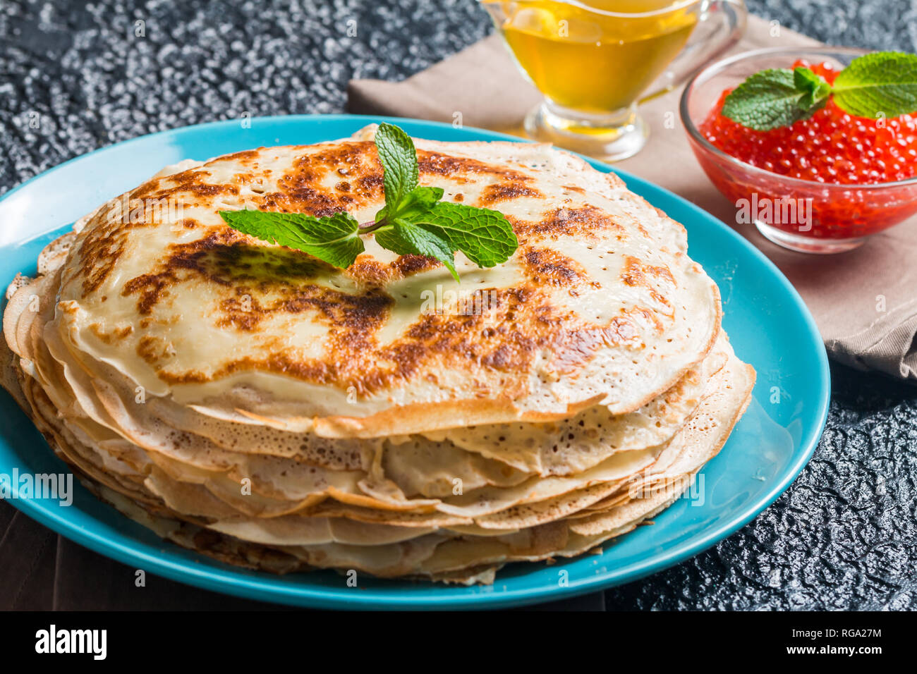 Stack of yeast pancakes, traditional for Russian pancake week witn red ...