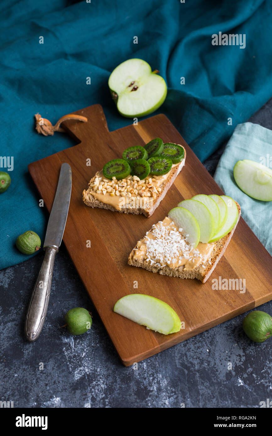 Bread slices with various toppings on wooden board Stock Photo - Alamy