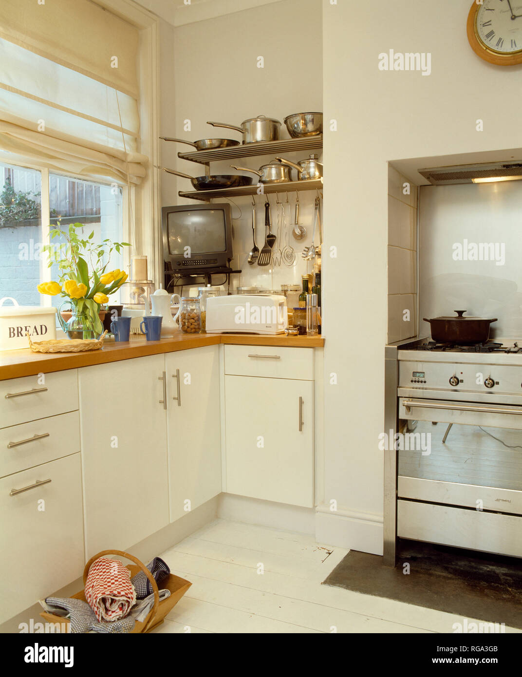 Small white kitchen with range oven Stock Photo - Alamy