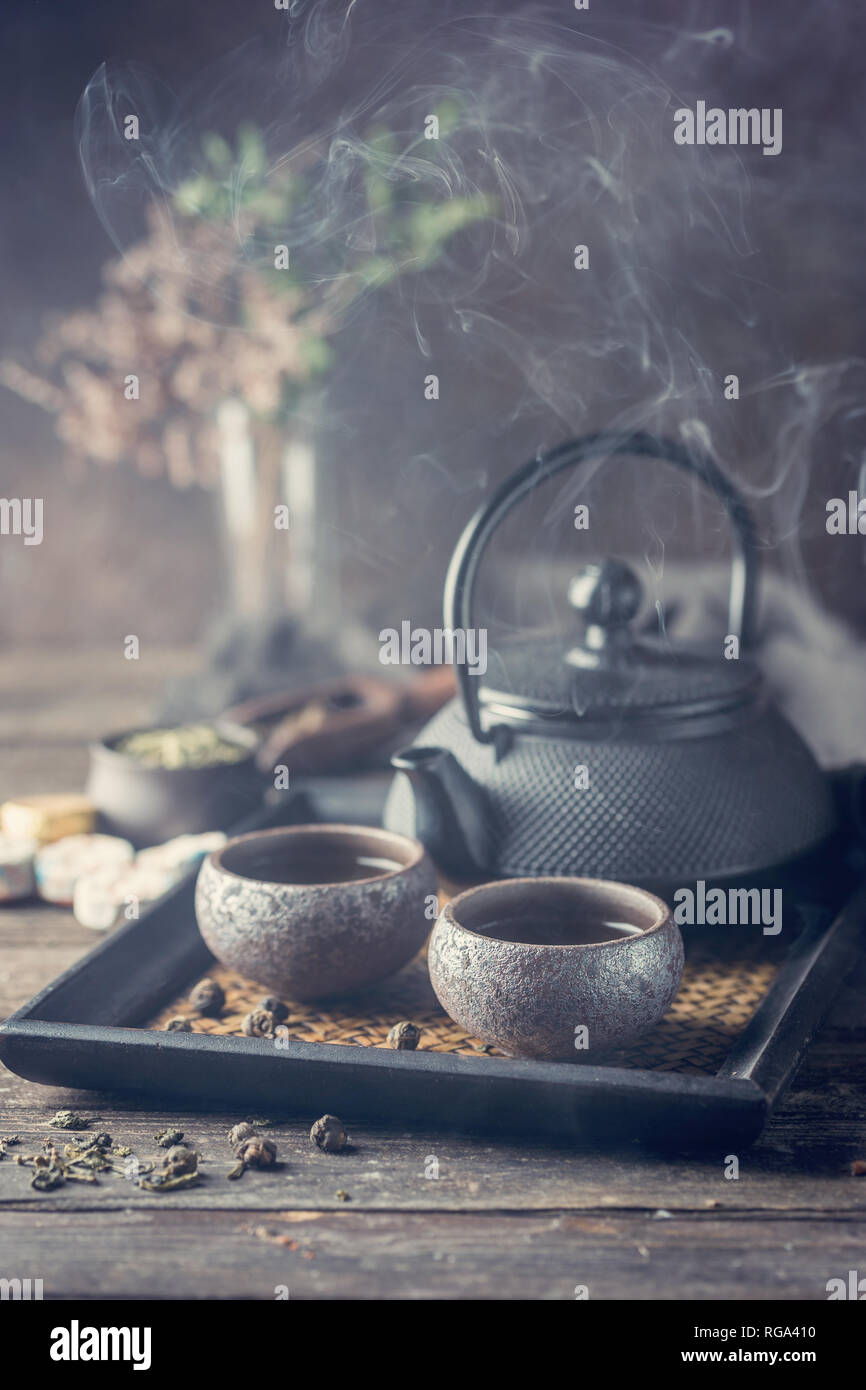 Still-life of japanese healthy green tea in a small cups and teapot ...