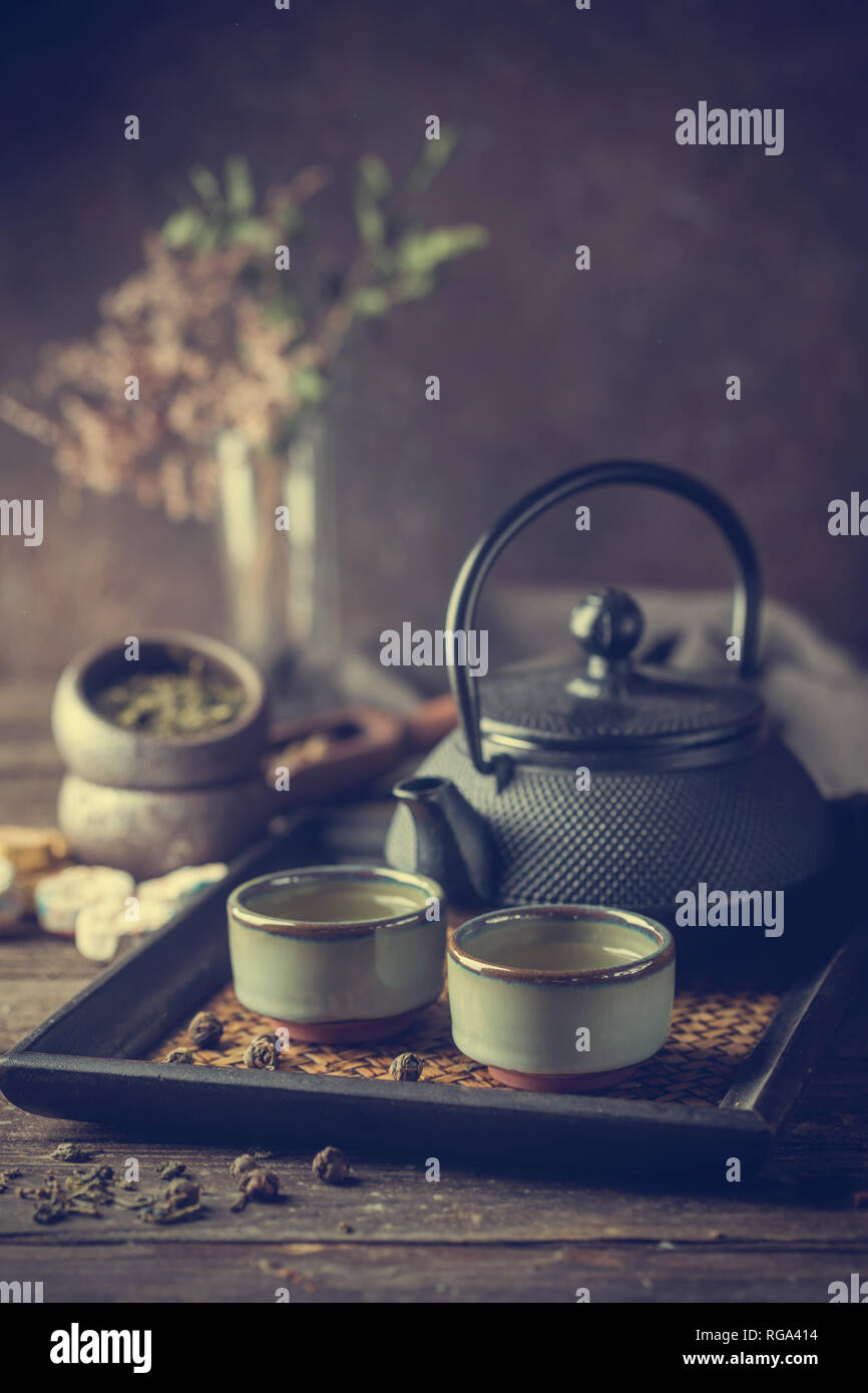 Still-life of japanese healthy green tea in a small cups and teapot ...
