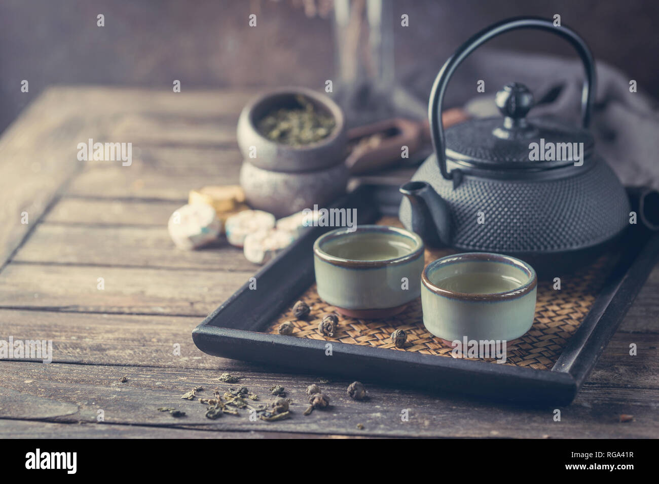 Still-life of japanese healthy green tea in a small cups and teapot ...
