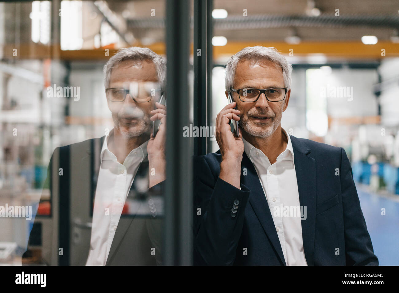 Manager talking on the phone in high tech company Stock Photo - Alamy