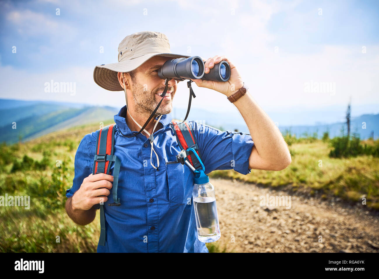 Man looking through binoculars hi-res stock photography and images - Alamy
