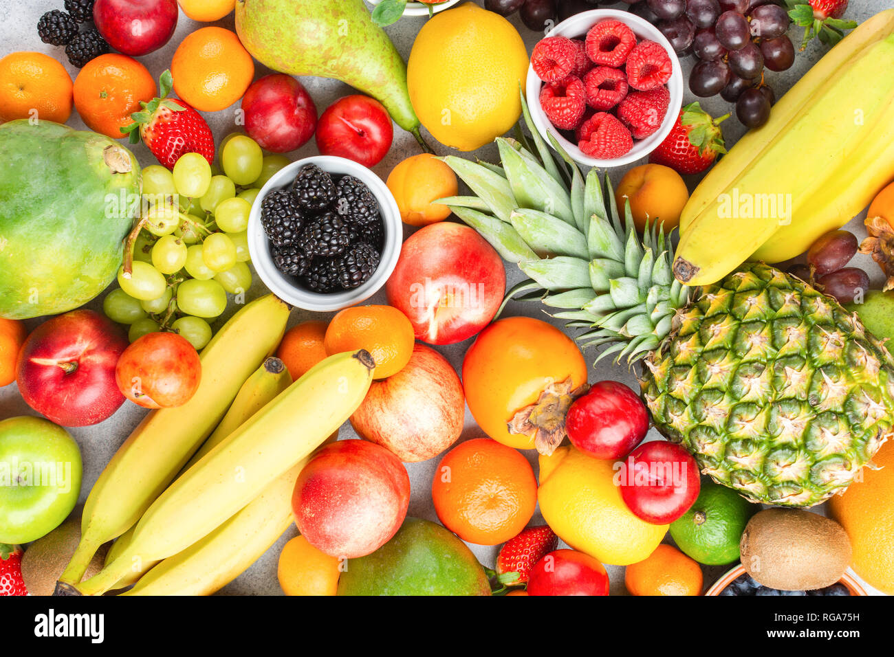 Healthy fruit background filled with strawberries raspberries oranges ...
