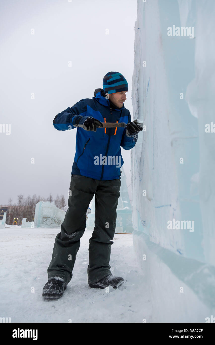 Christmas tree from a block of ice with a chisel Stock Photo - Alamy