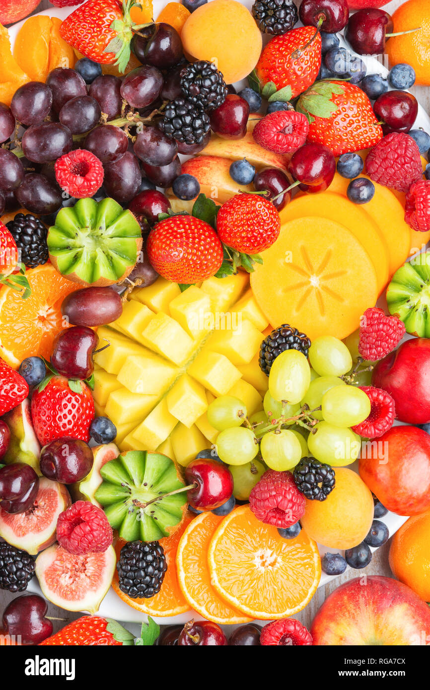Healthy fruit background filled with strawberries raspberries oranges ...