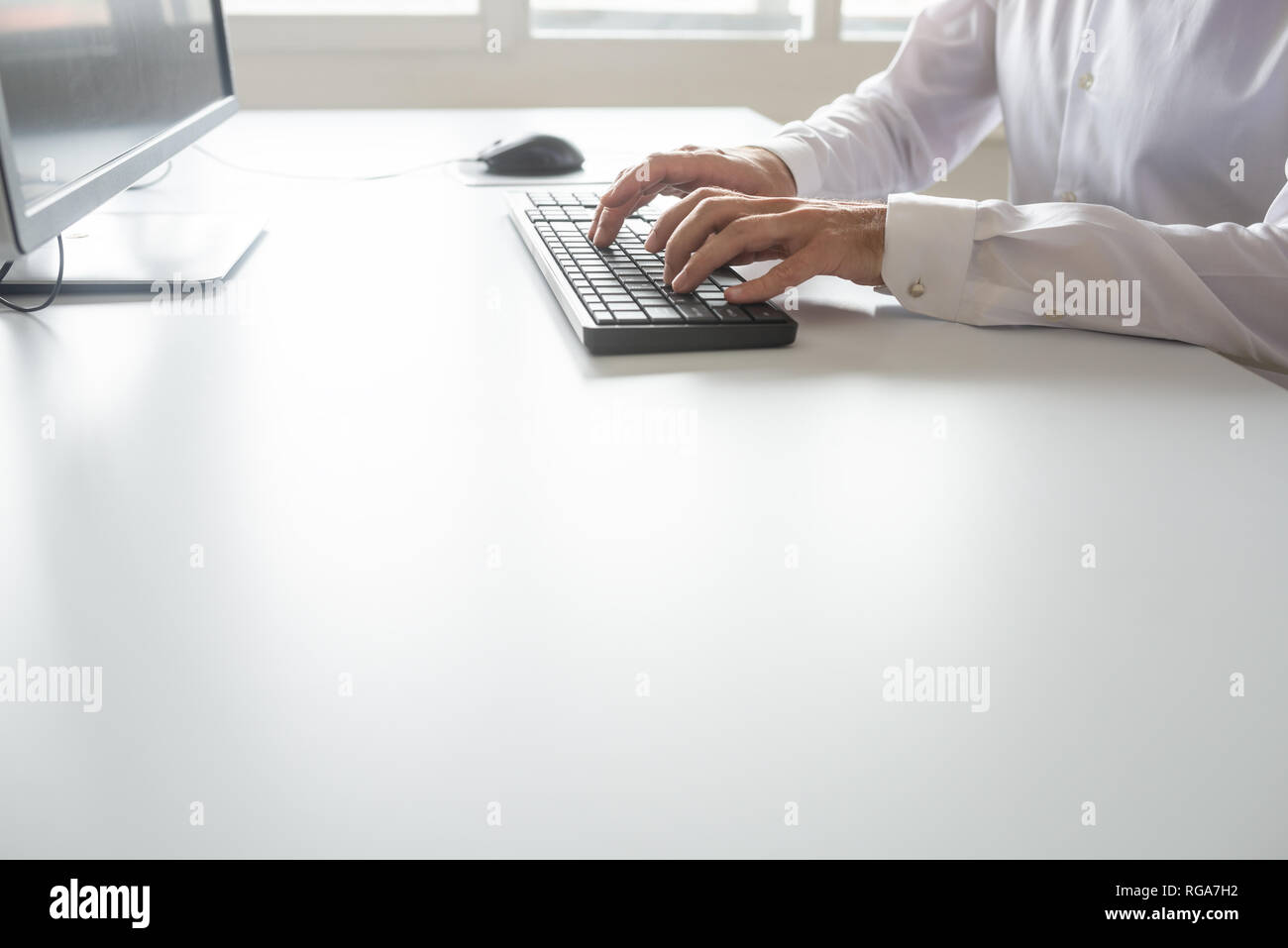 Programmer or student sitting at his office desk working using computer ...