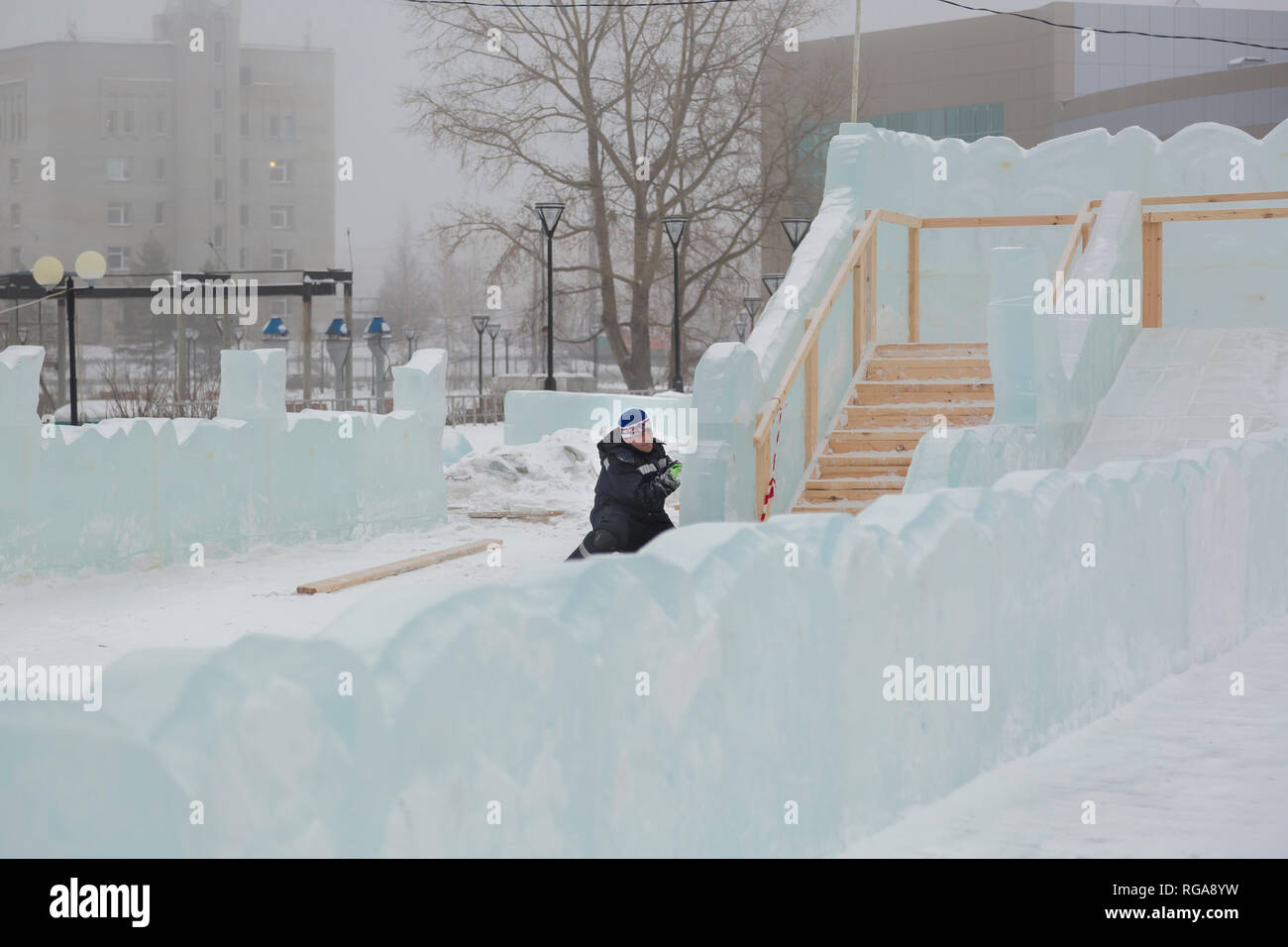 The sculptor cuts an ice figure out of an ice block with a chisel Stock ...