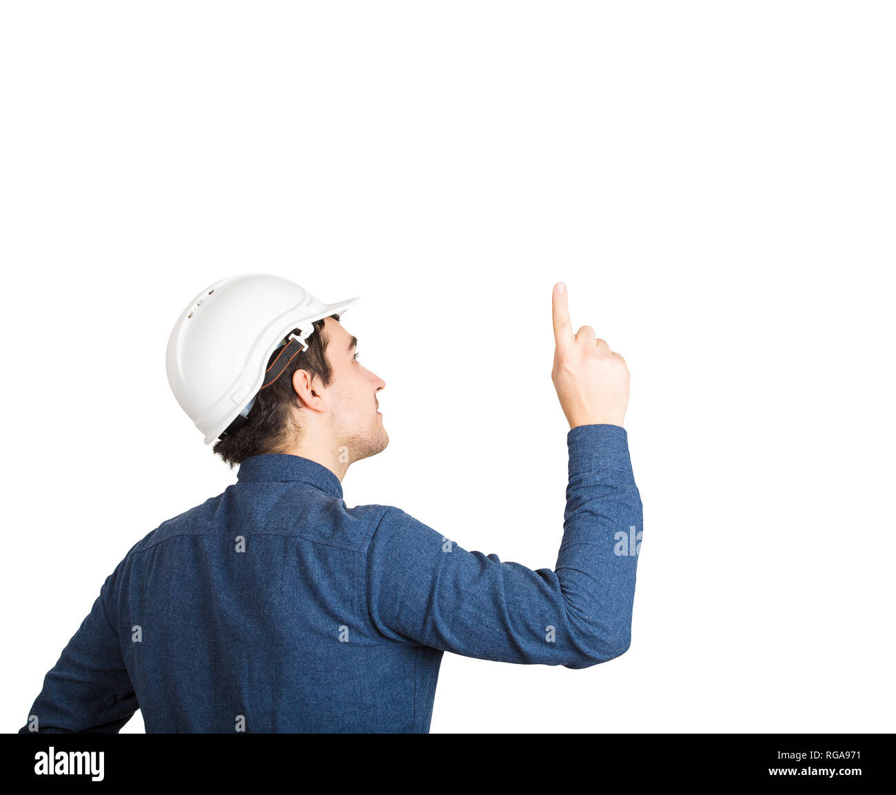 Rear view of young man engineer wearing protective helmet pointing ...