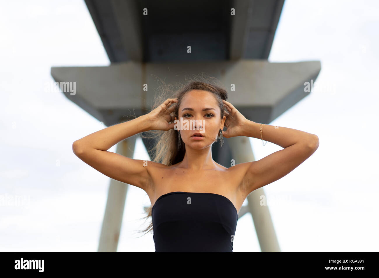Portrait of beautiful young woman under a bridge Stock Photo - Alamy