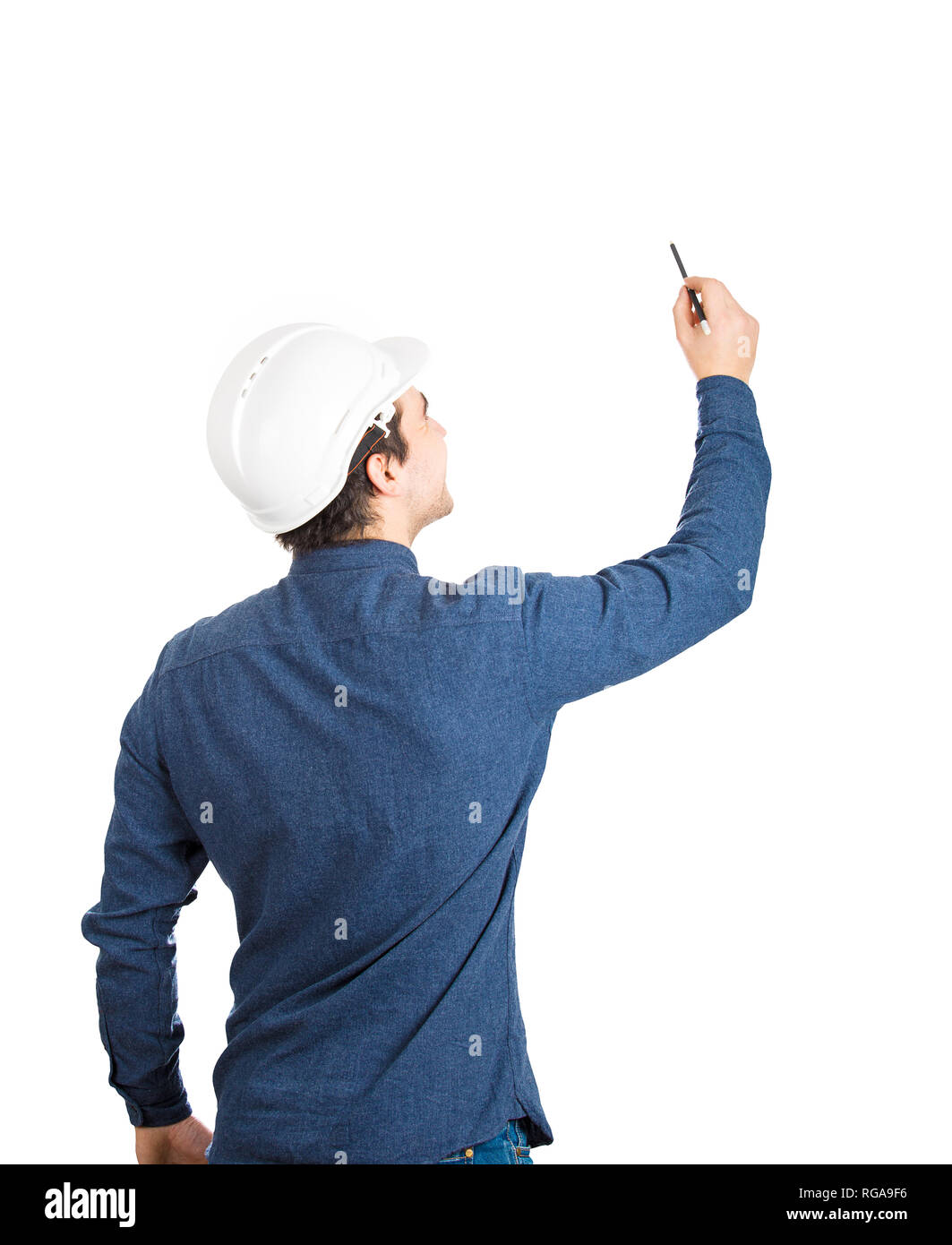 Rear view young man engineer wearing protective helmet pencil drawing ...