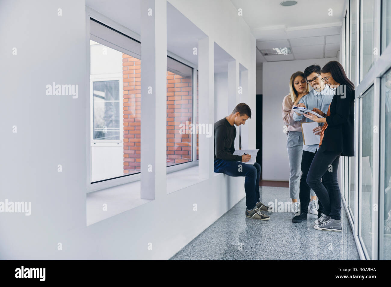 Group of students standing in hallway with documents Stock Photo - Alamy