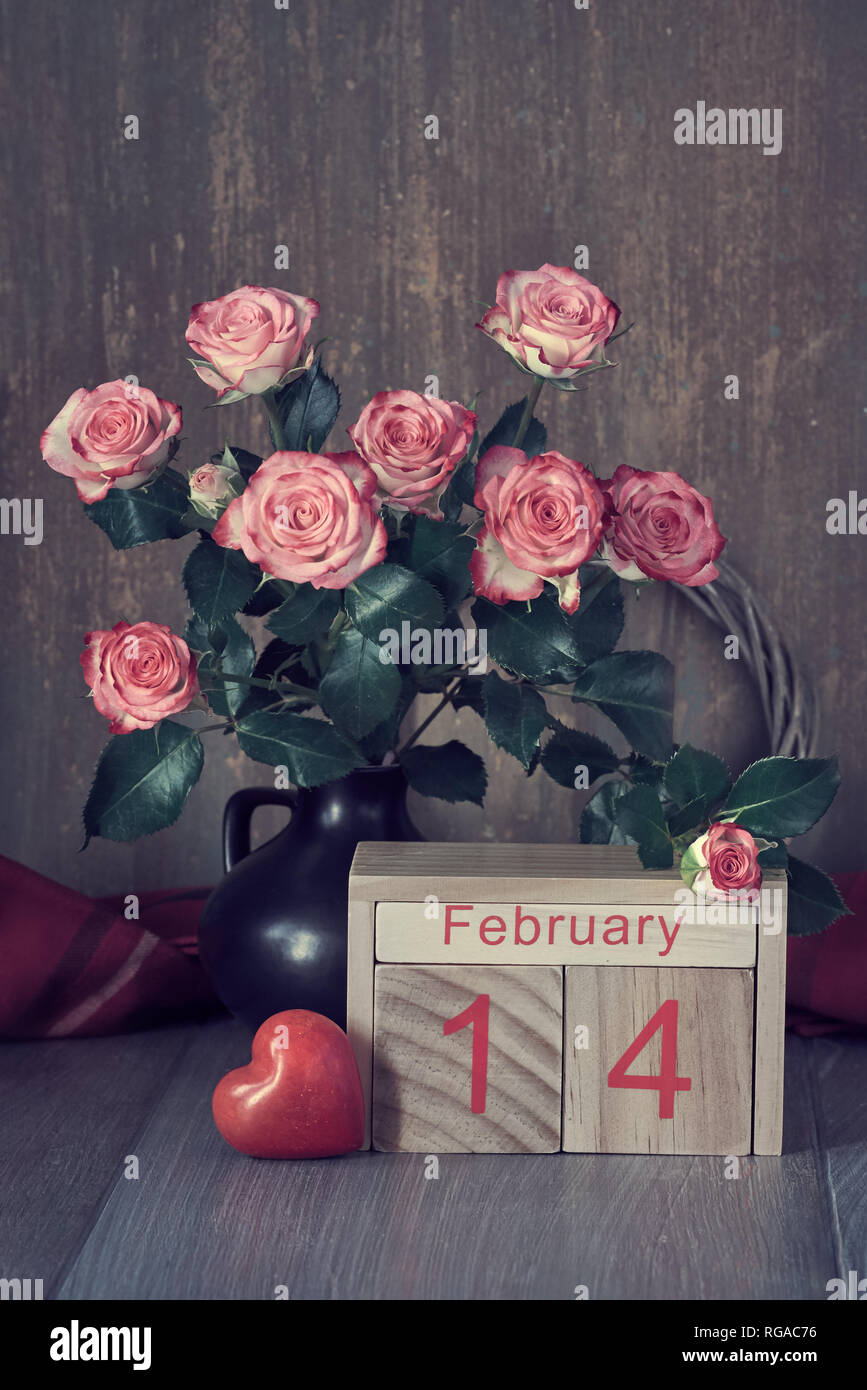 Valentine's day still lifewith wooden calendar, pink roses and hearts ...