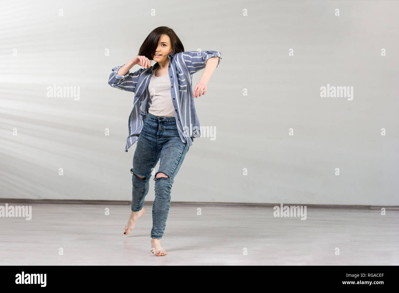 Young pretty dancer in dynamic pose. Beautiful energetic modrrn style ...