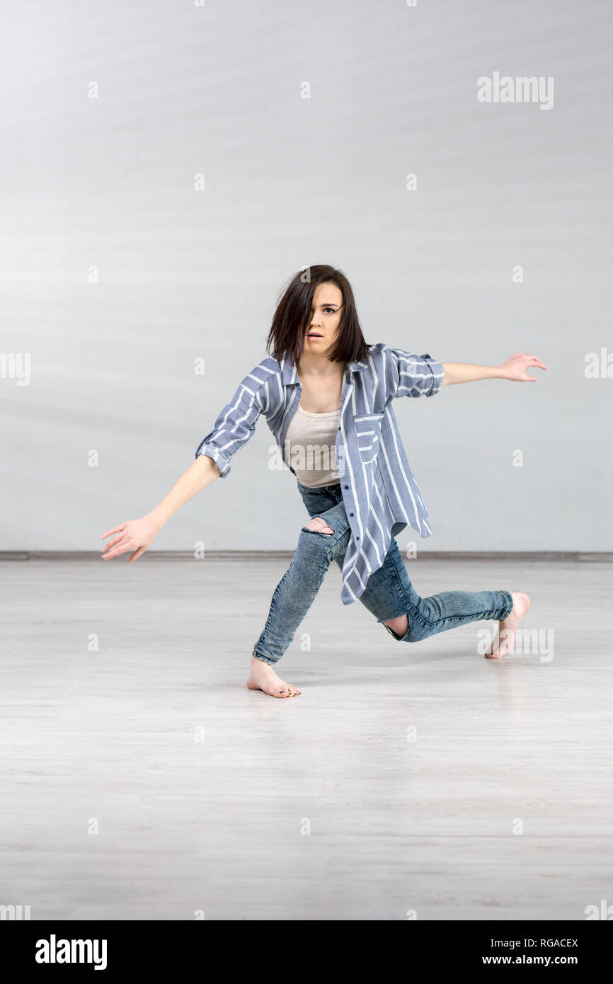 Pretty dancer girl in movement. Beautiful slim girl performing modern ...