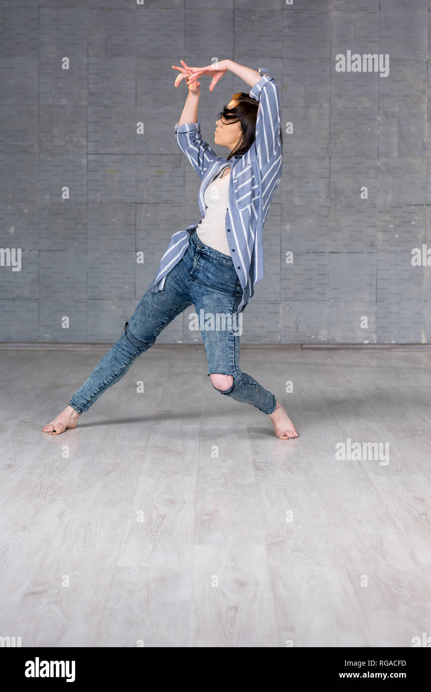 Young female dancer in movement. Modern style dancer practicing dance ...