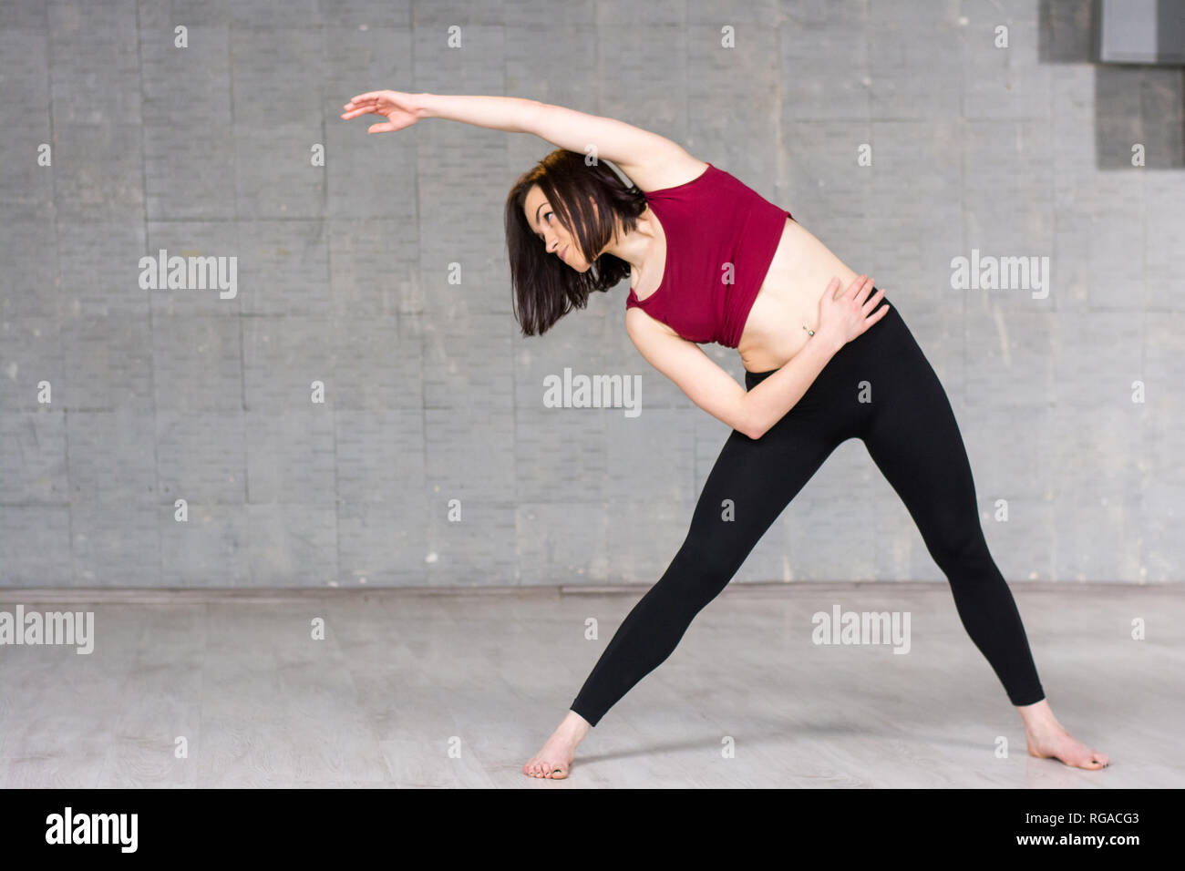 Young sportive woman working out. Young slim woman in sportive clothing ...