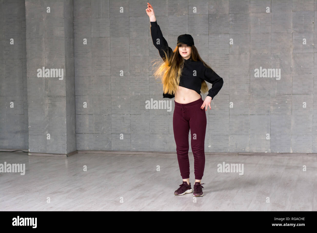 Young hip-hop dancer raised hand. Young beautiful dancer of modern ...