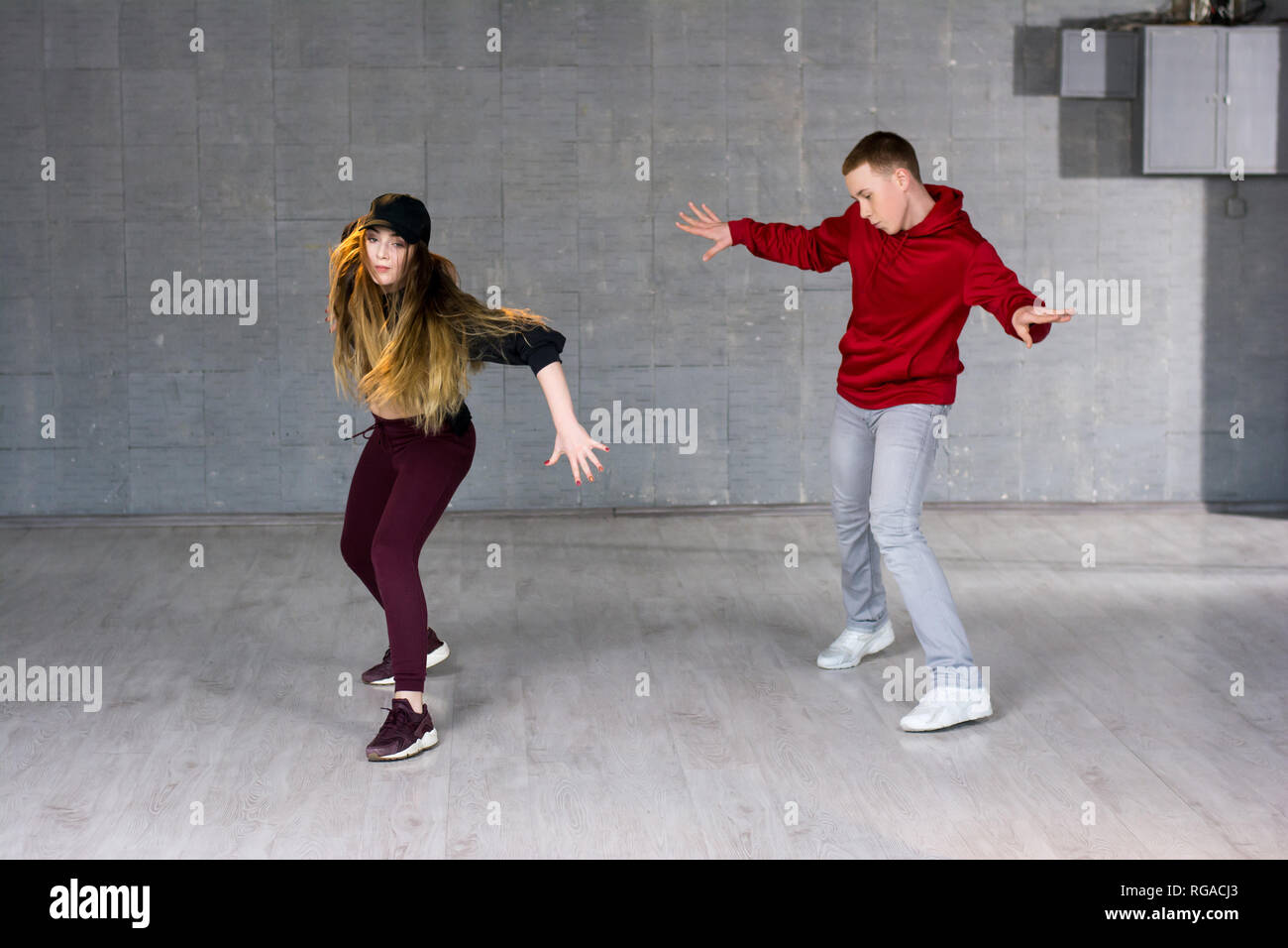Attractive casual couple dancing hip-hop. Two modern style beautiful ...