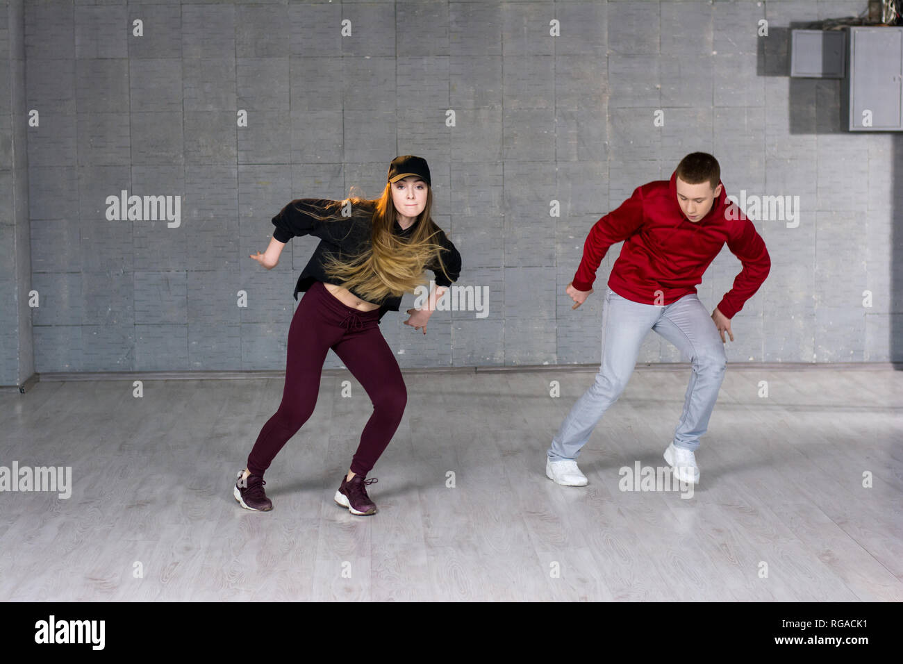 Couple of freestyle dancers in motion. Performing of hip-hop by couple ...