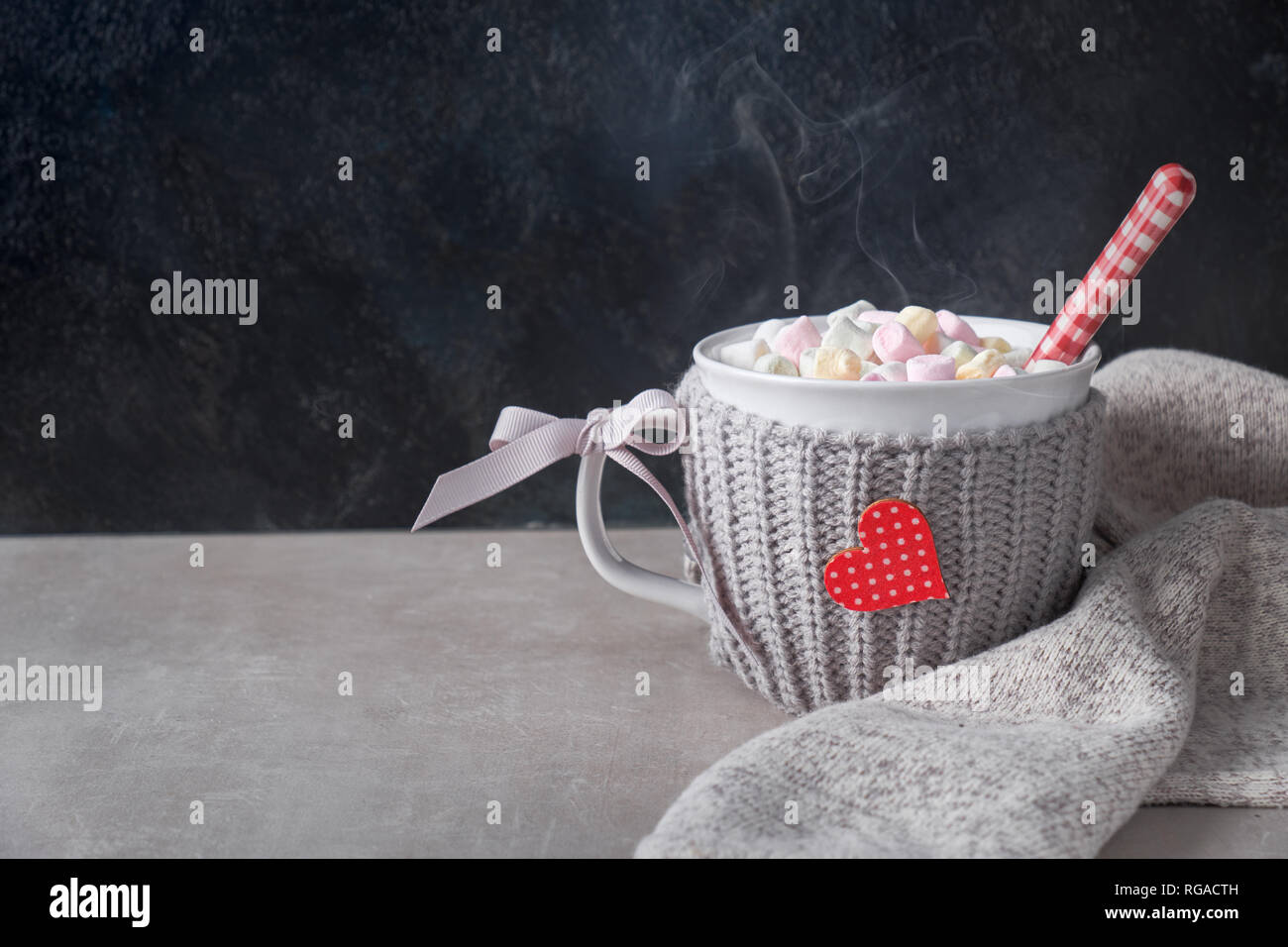 Hot chocolate with marshmallows, red heart on the cup on the table ...