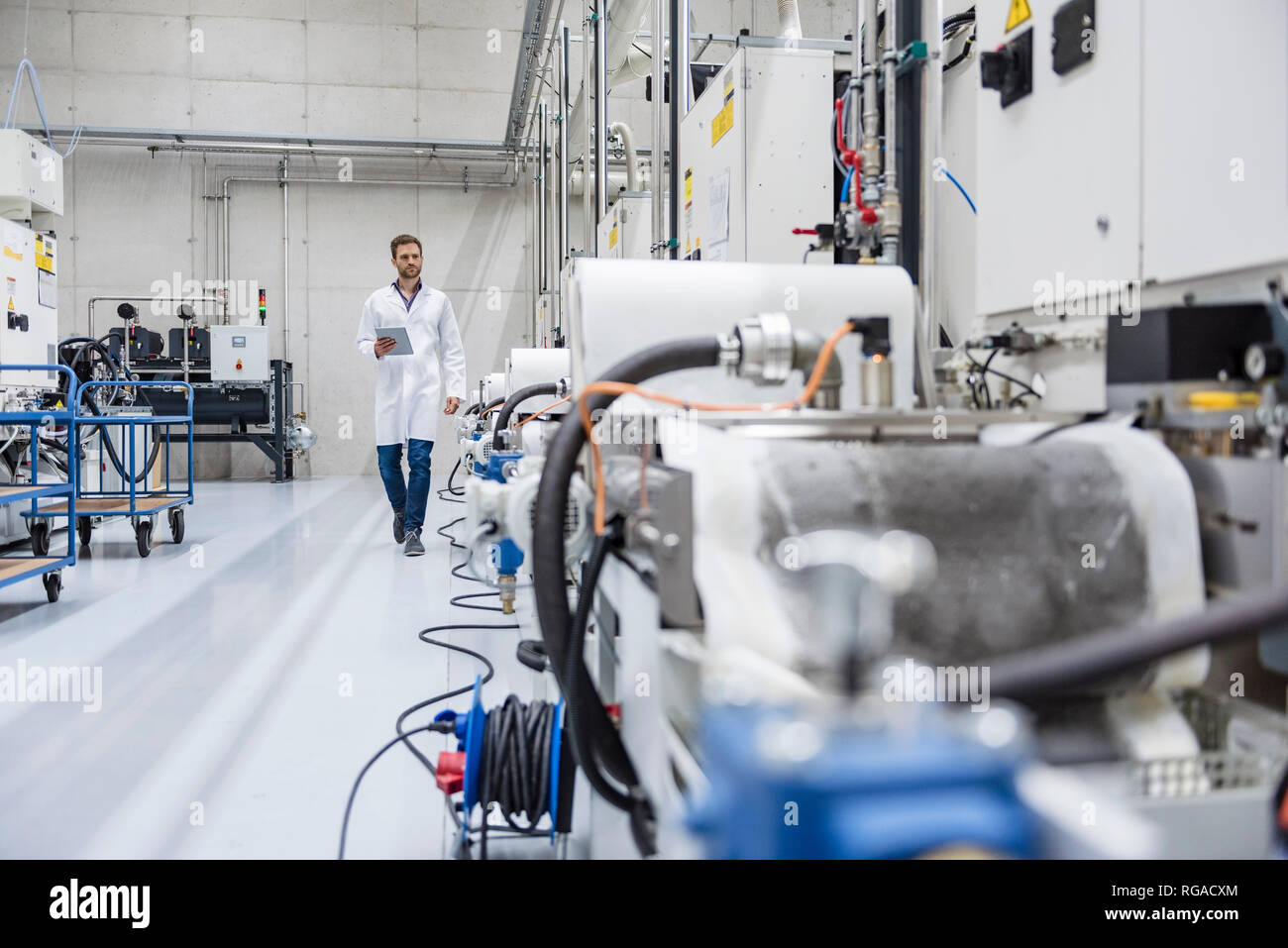 Employee checking manufacturing machines high tech company hi-res stock ...