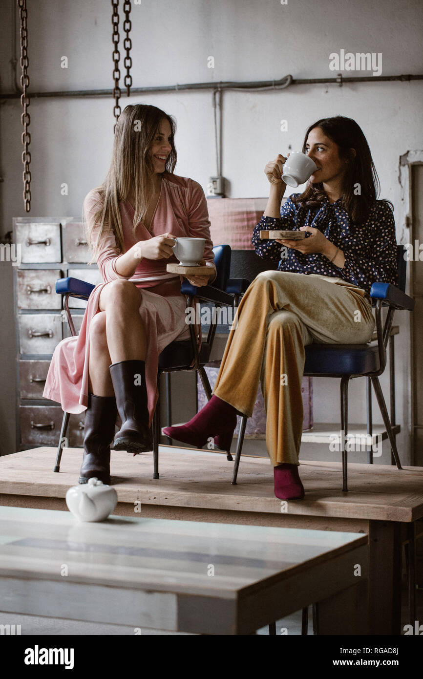 Two friends drinking tea together in a loft Stock Photo - Alamy