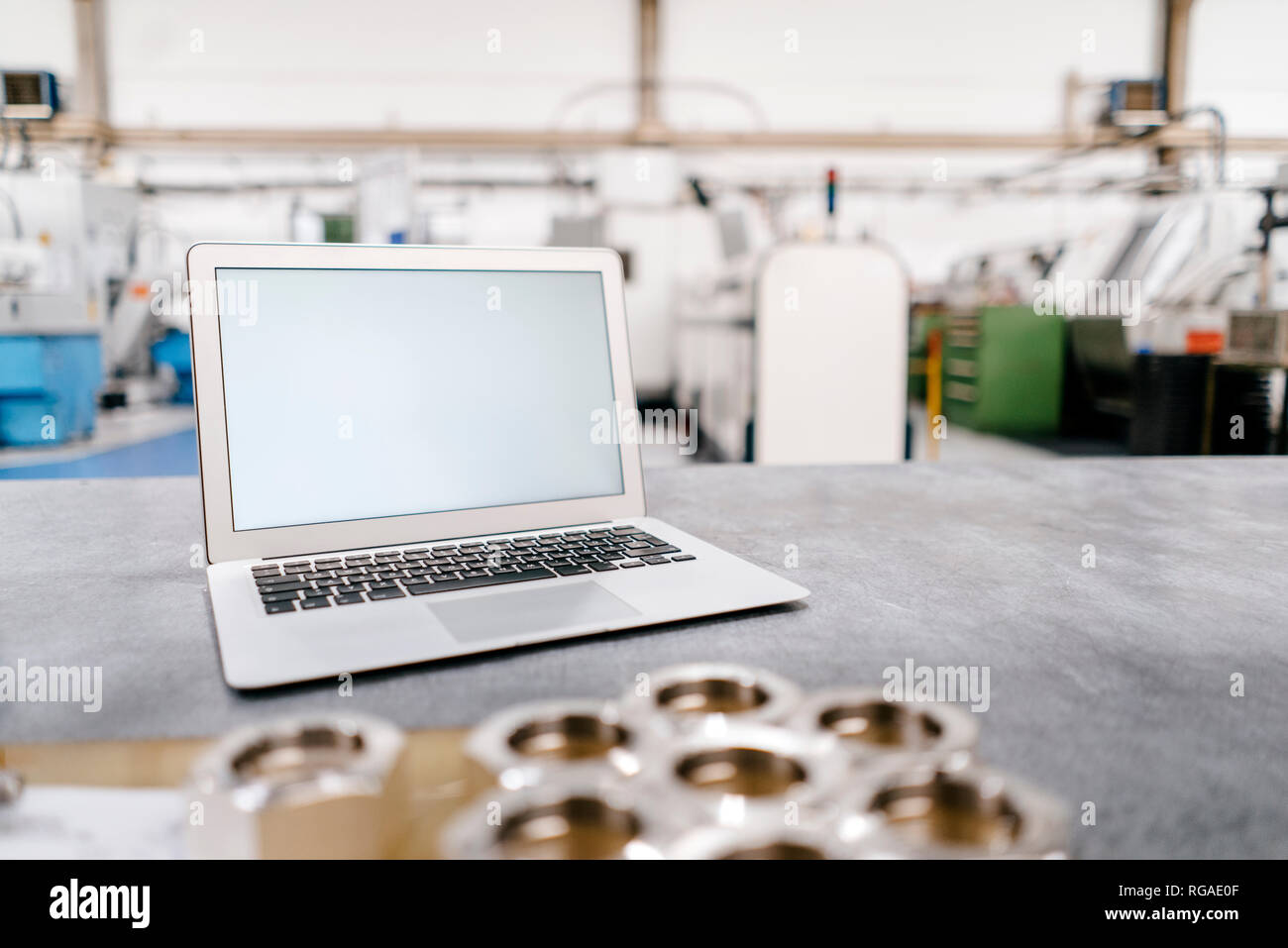 Laptop with blank screen in factory workshop Stock Photo - Alamy