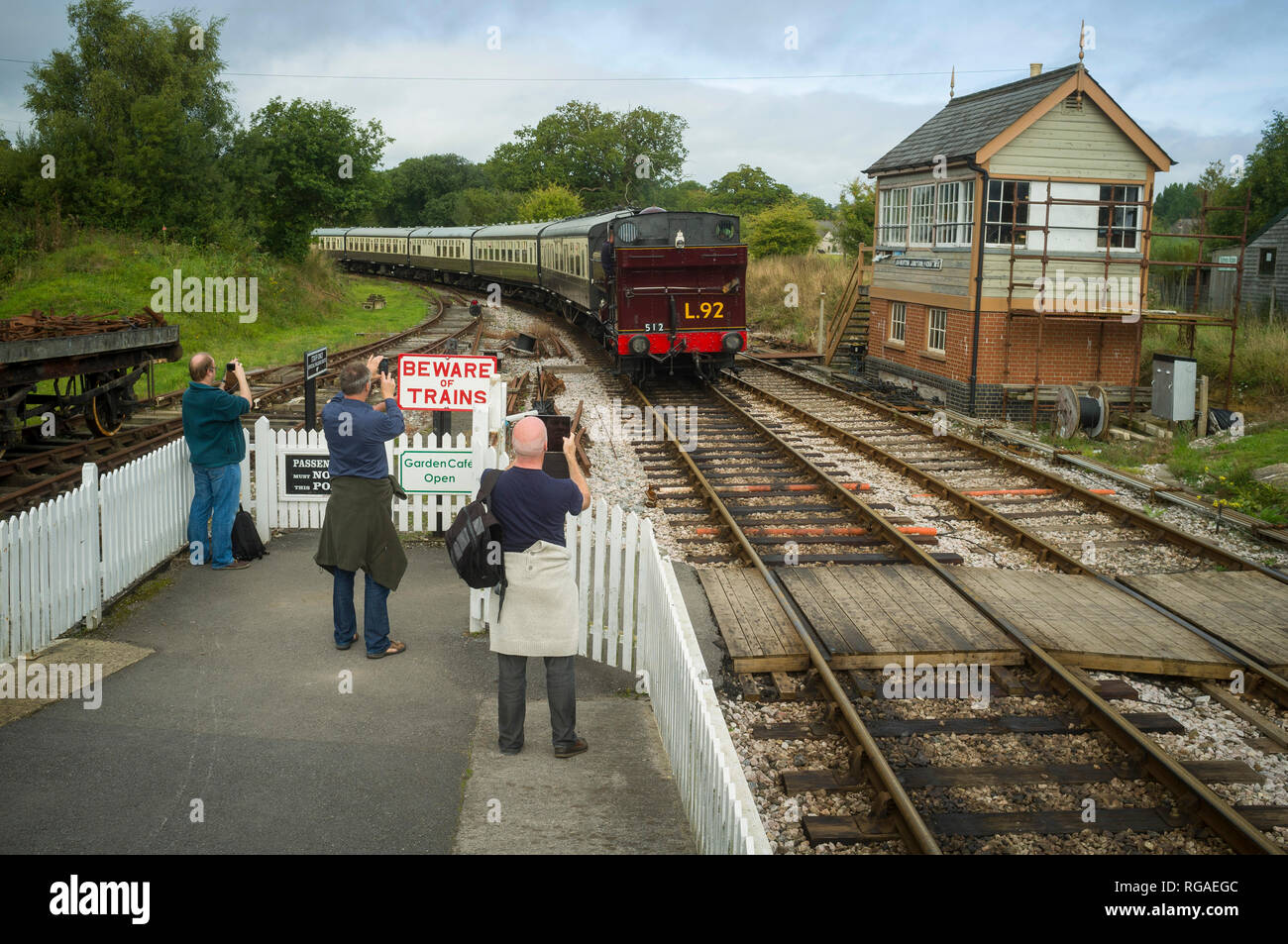 Train enthusiasts photograph a steam train of the South Devon Railway ...
