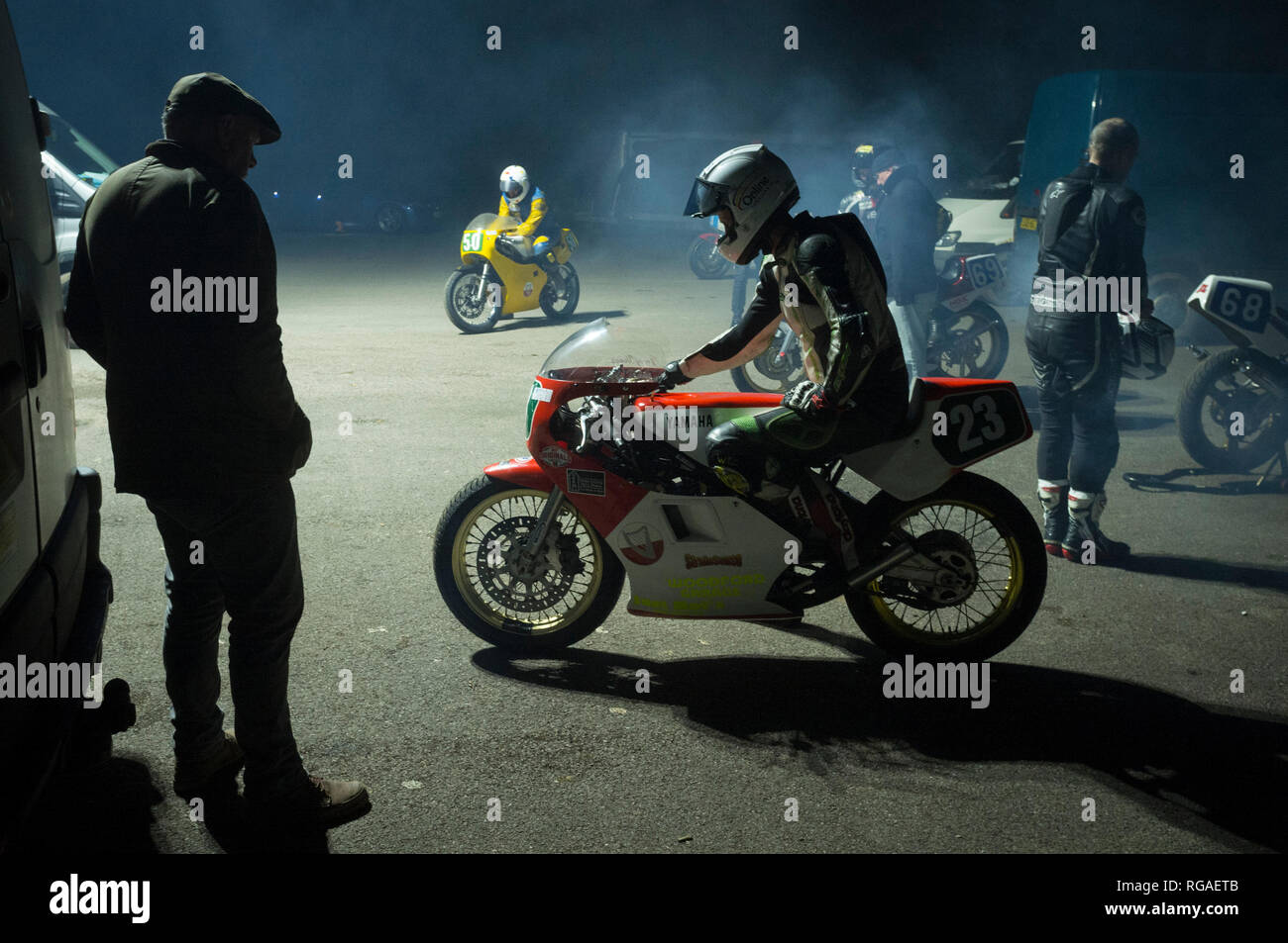 Motorcycle riders prepare in the cold to ride through the dinner guests ...