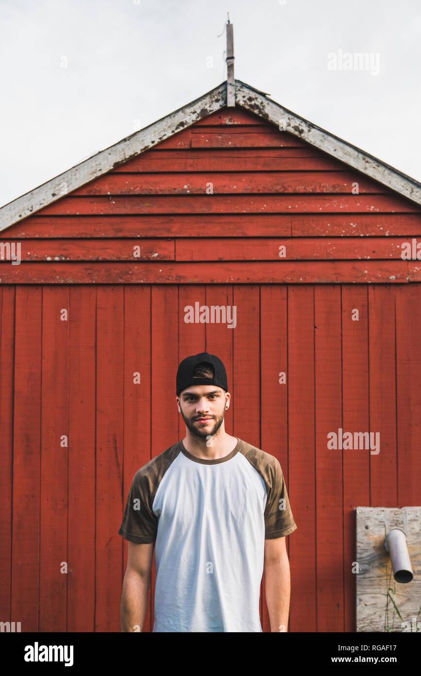 Young man standing front red barn hi-res stock photography and images ...