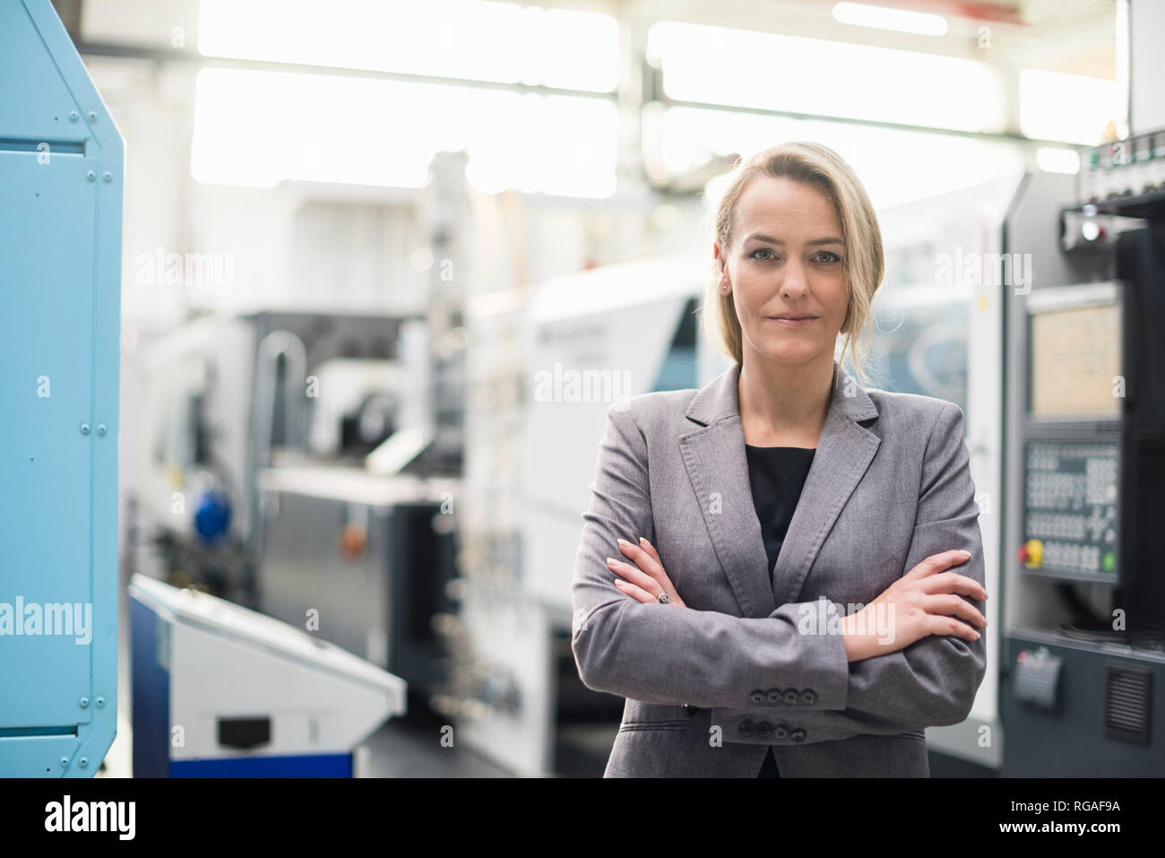 Portrait of confident woman in factory shop floor Stock Photo - Alamy