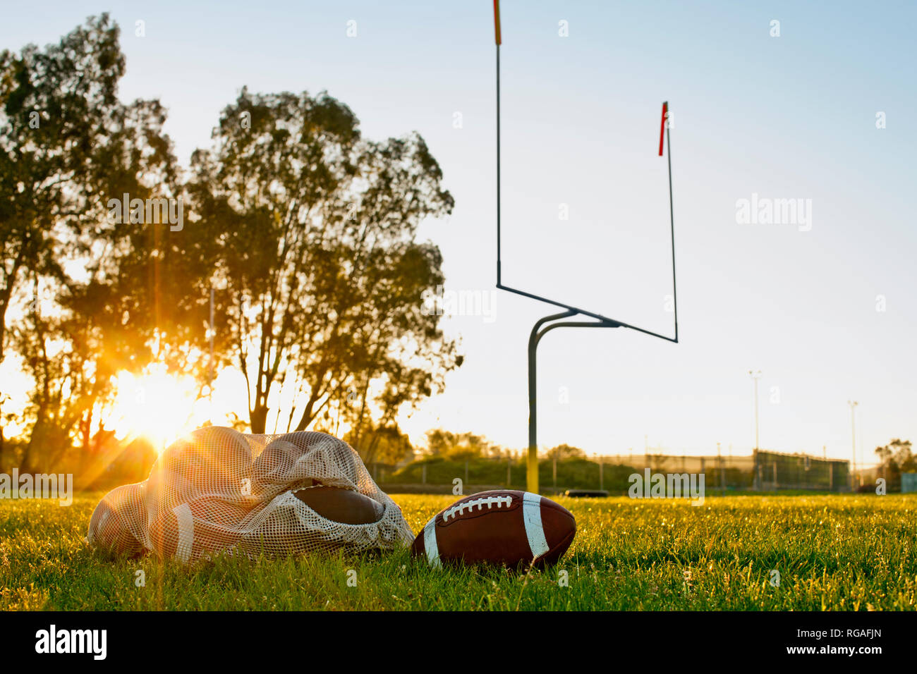 Goal posts and footballs on a football field Stock Photo - Alamy