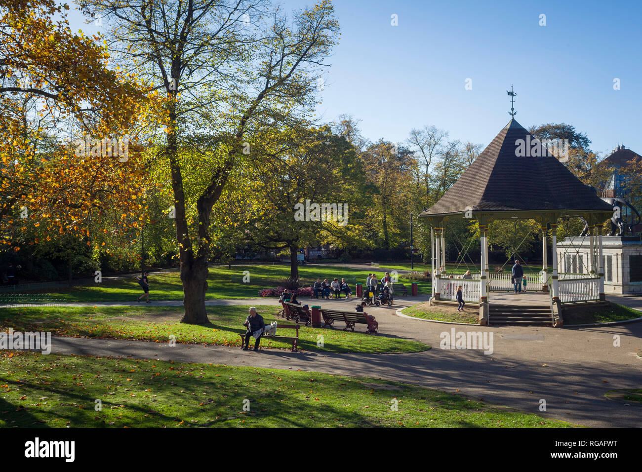 People enjoy some late Autumn sunshine by the bandstand in Forbury ...
