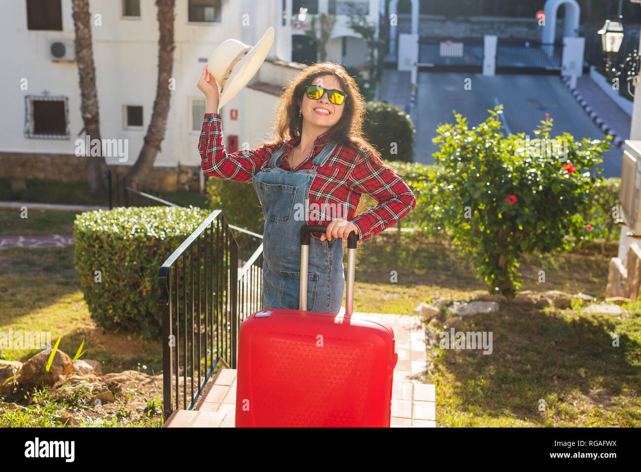 Journey, holidays and summer concept - young woman with red travel ...
