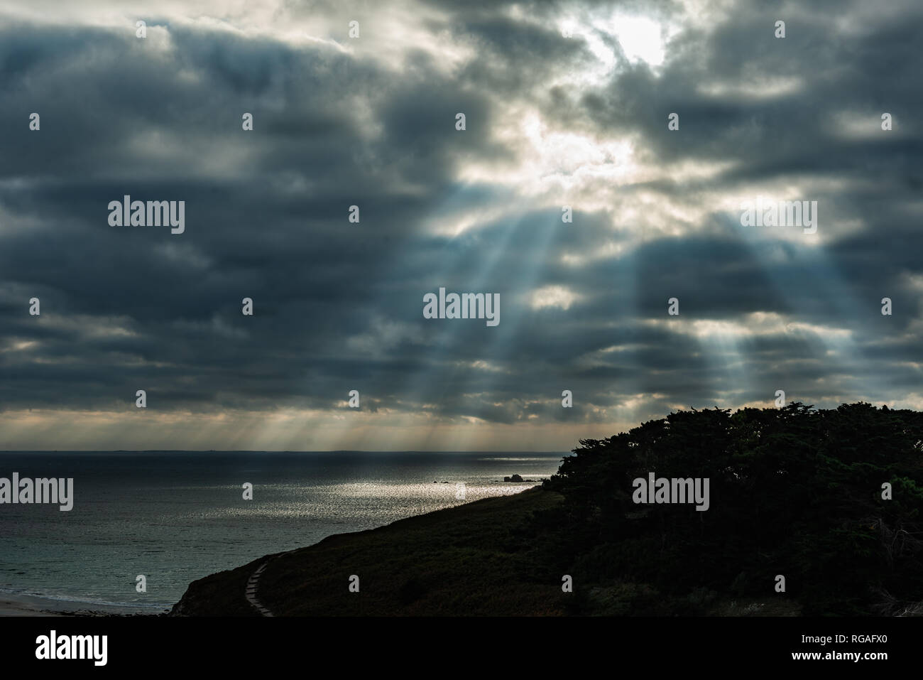 sunbeams break through cloud cover and produce light spots on the water ...