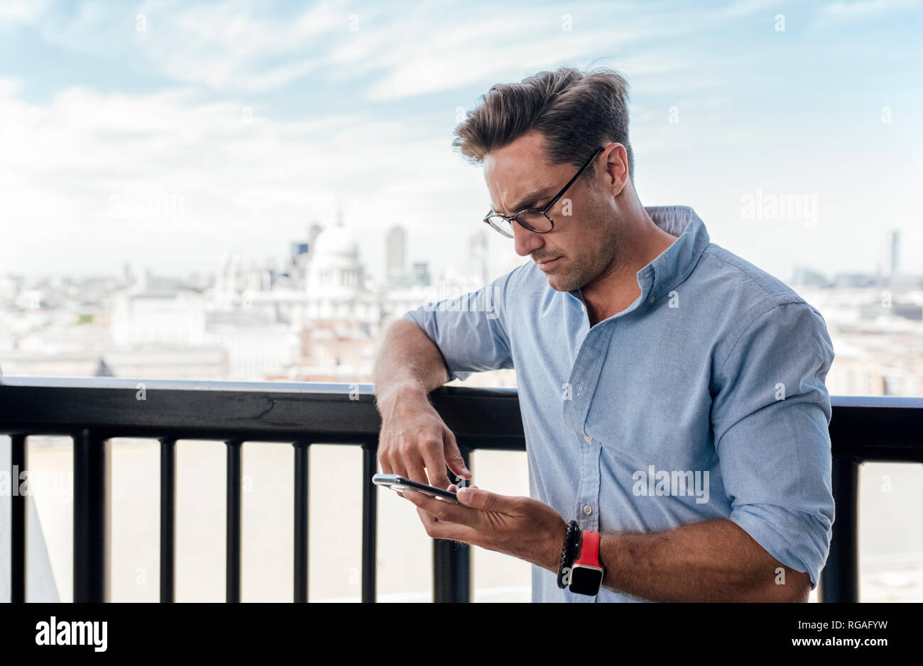 Man using cell phone roof terrace hi-res stock photography and images ...