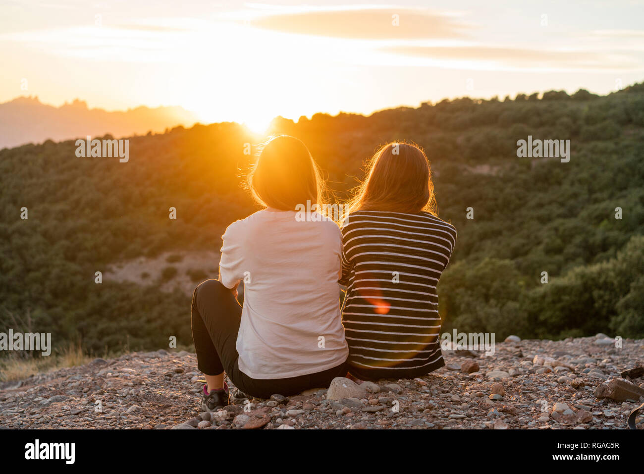 Back view two friends sit hi-res stock photography and images - Alamy