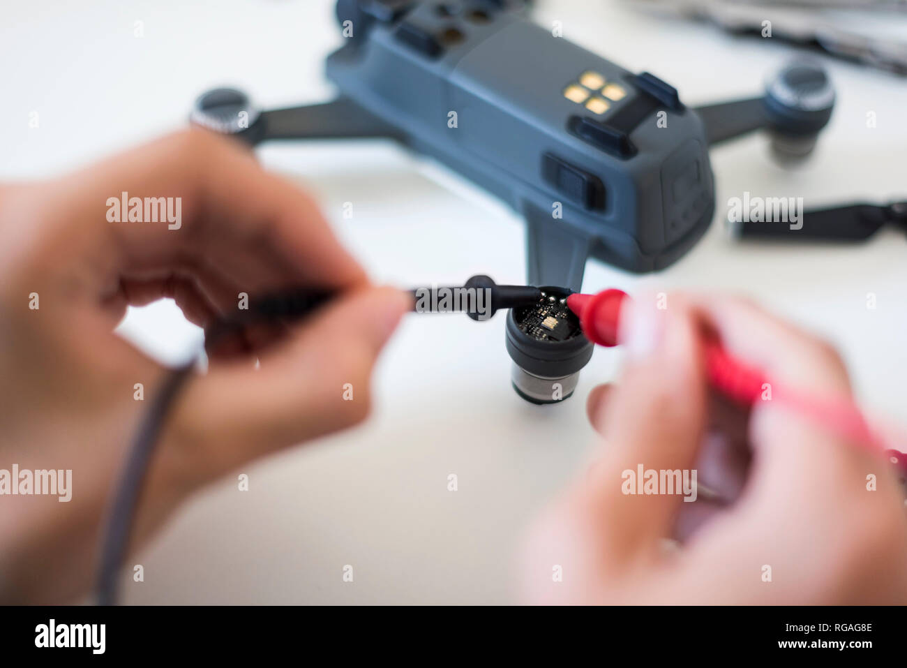 Boy repairing drone Stock Photo - Alamy