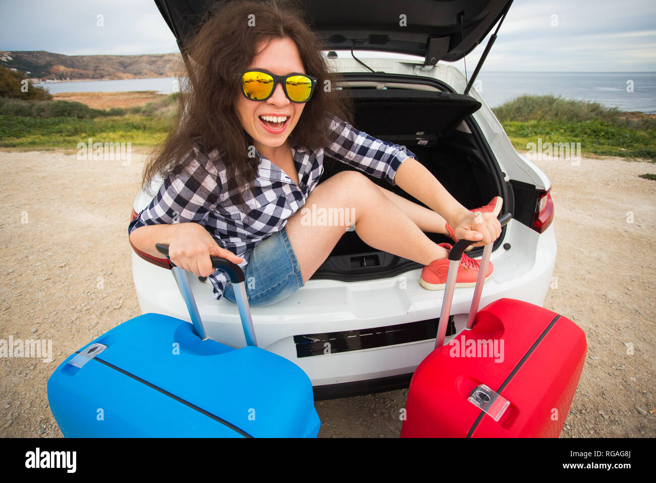 Girl sitting in back of car smiling and showing thumbs up. Young ...